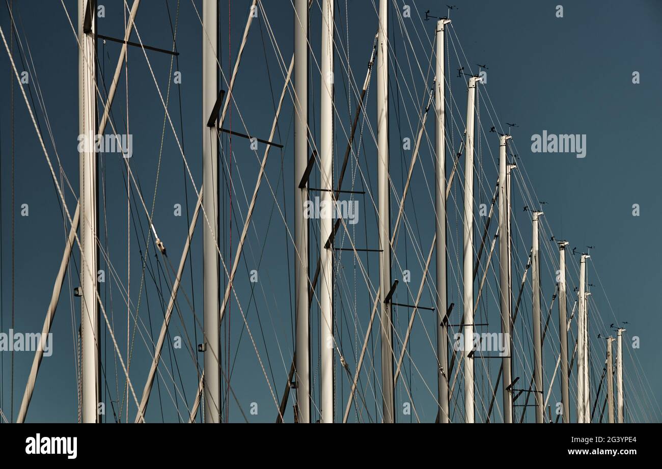 The number of masts of sailboats with the blue sky on a background, a ...
