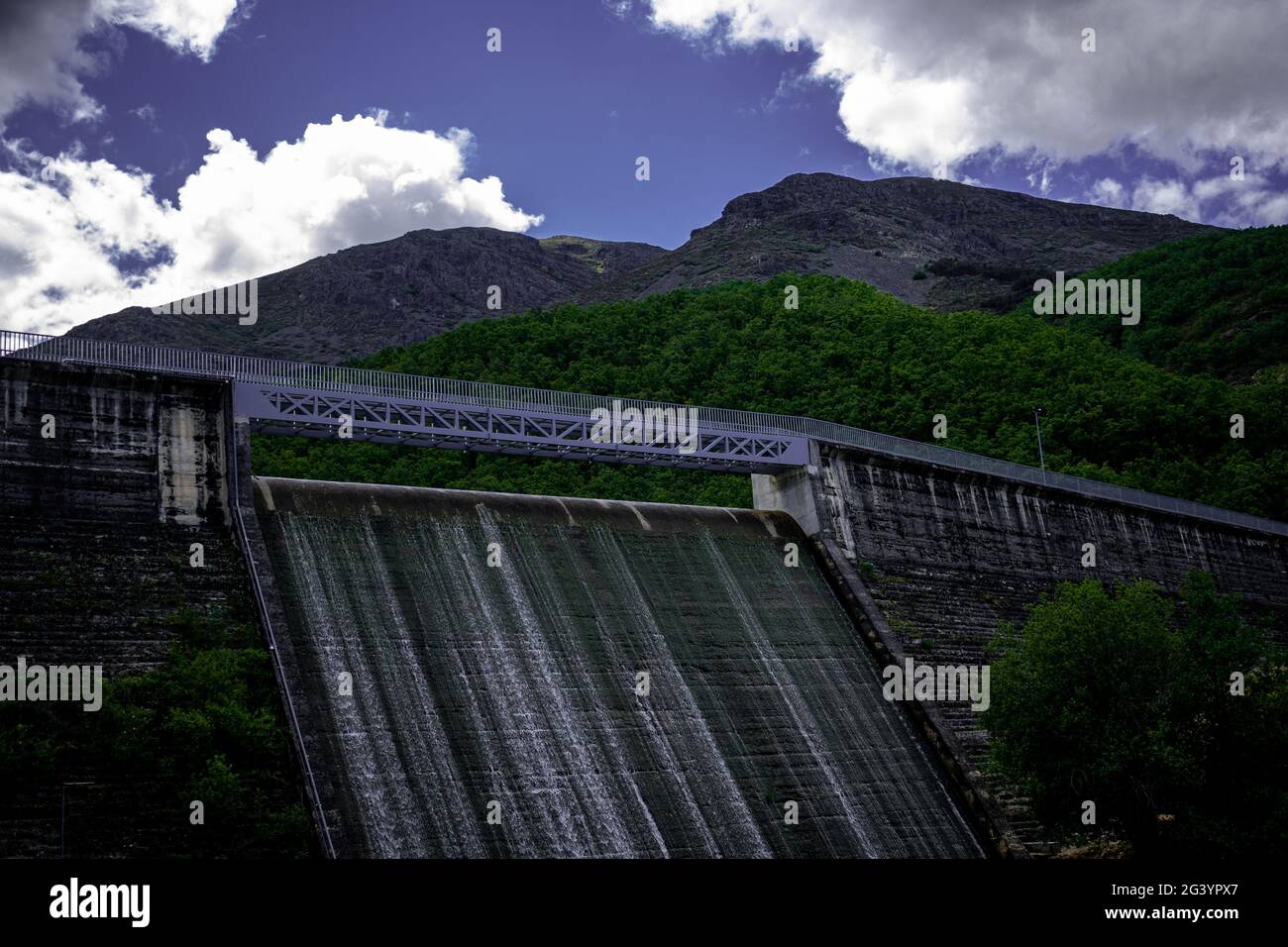 Natural view of a dam with mountainous landscape and bright sky ...