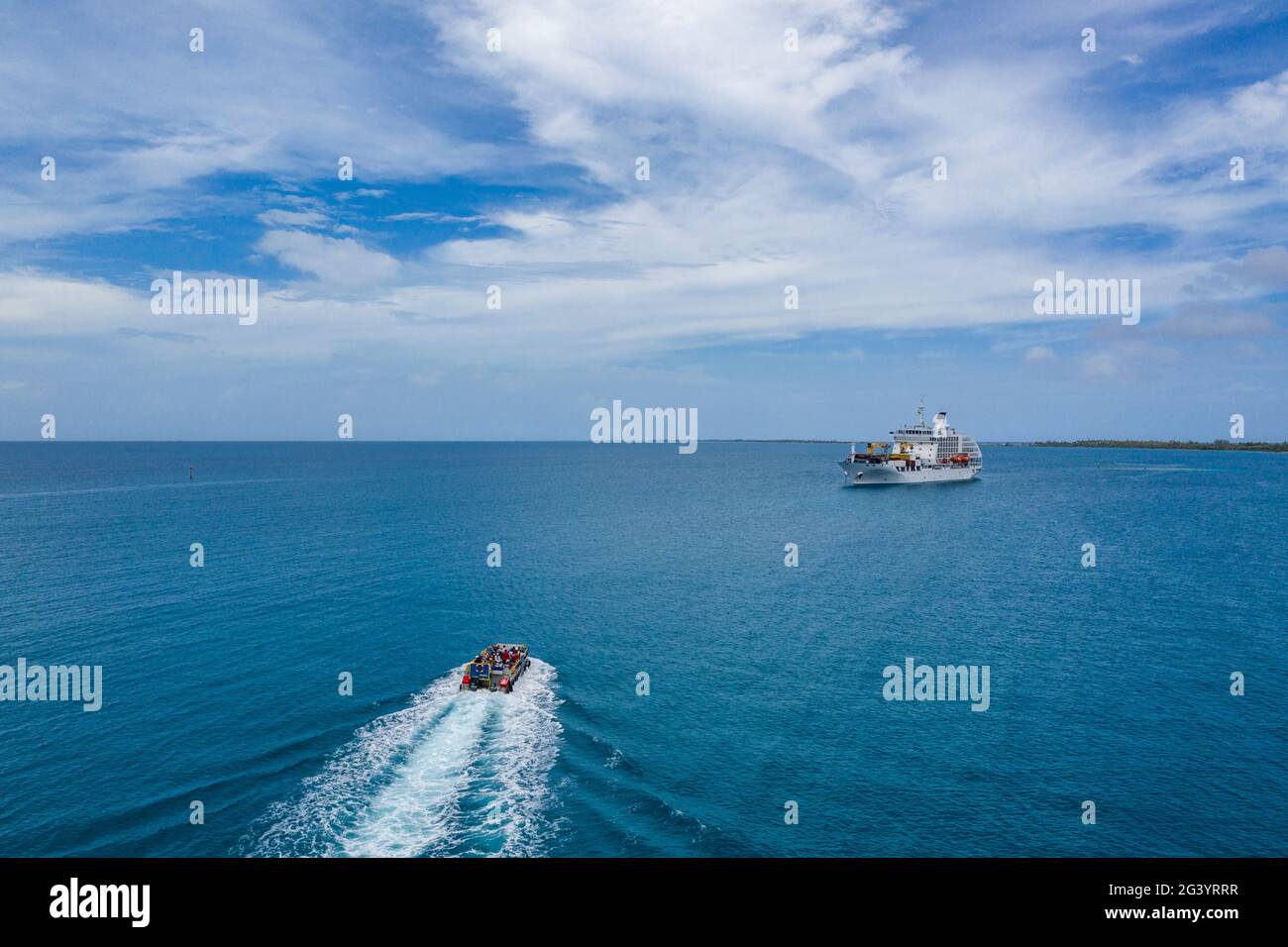Aerial view of passengers on dinghy on their way back to the Aranui 5 ...