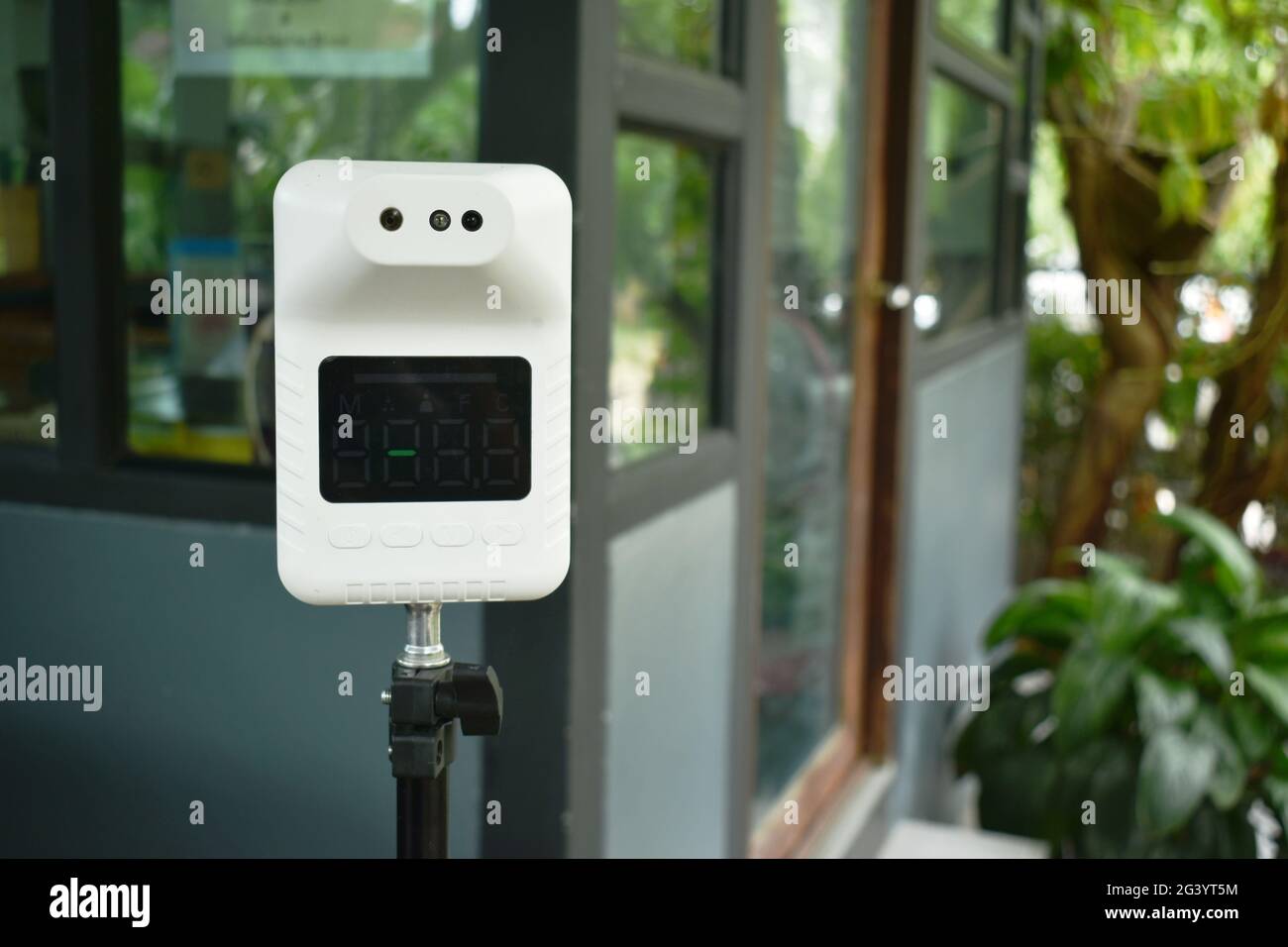 electric temperature measuring machine for virus in front of coffee ...