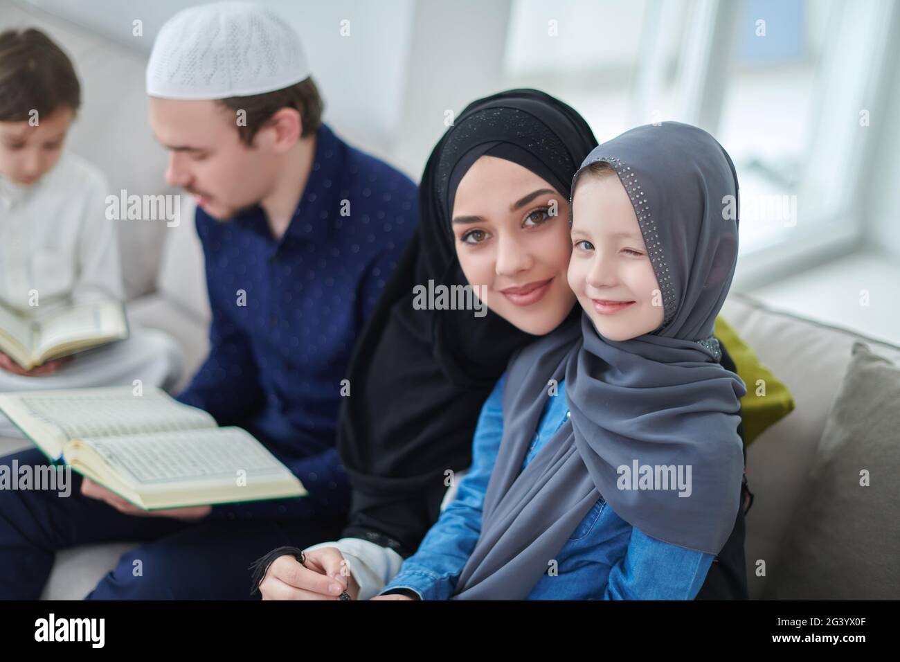 Young muslim family reading Quran during Ramadan Stock Photo - Alamy