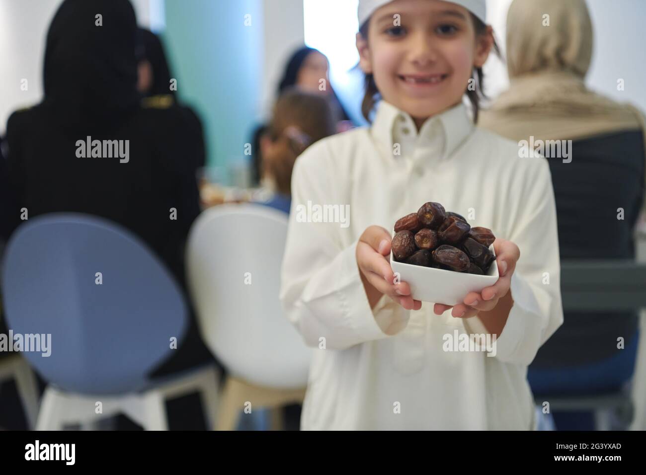 Arabian kid in the traditional clothes during iftar Stock Photo - Alamy