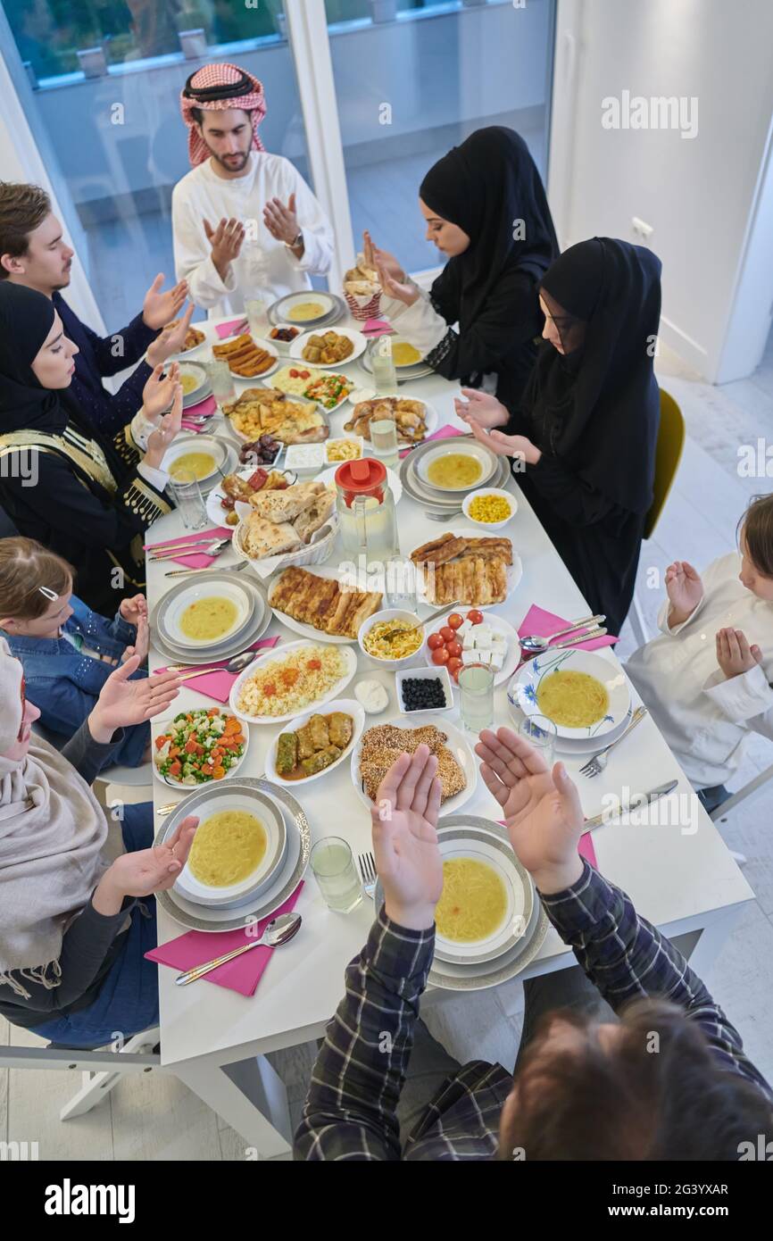 Muslim family making iftar dua to break fasting during Ramadan Stock ...