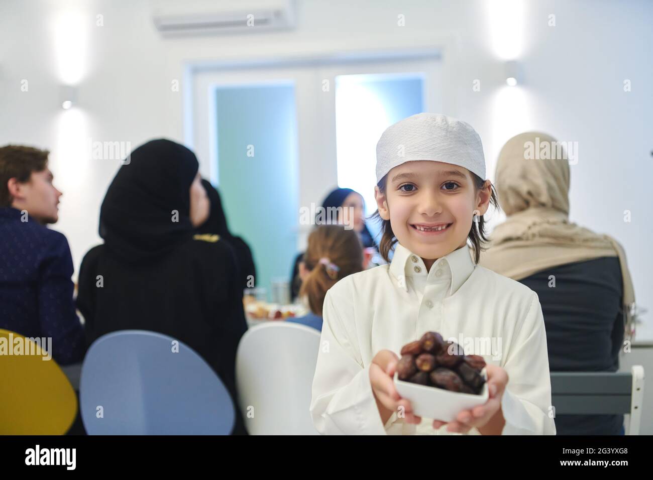 Arabian kid in the traditional clothes during iftar Stock Photo - Alamy
