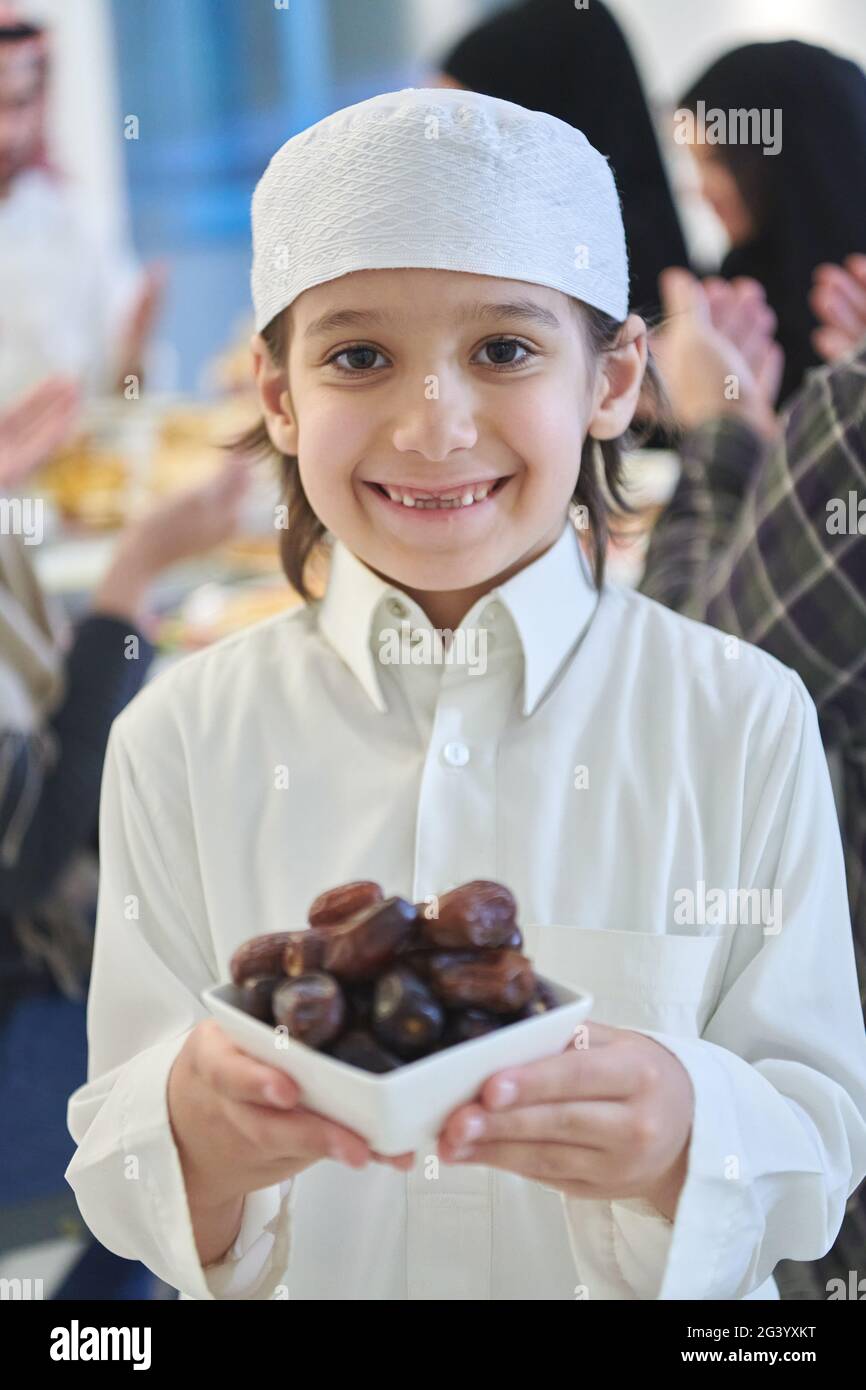 Arabian kid in the traditional clothes during iftar Stock Photo - Alamy