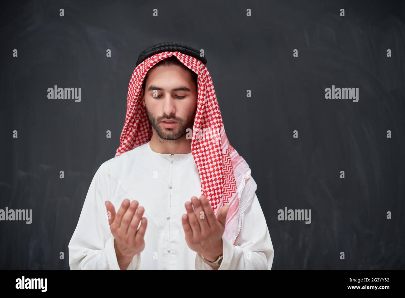 Arab man in traditional clothes praying to God or making dua Stock ...