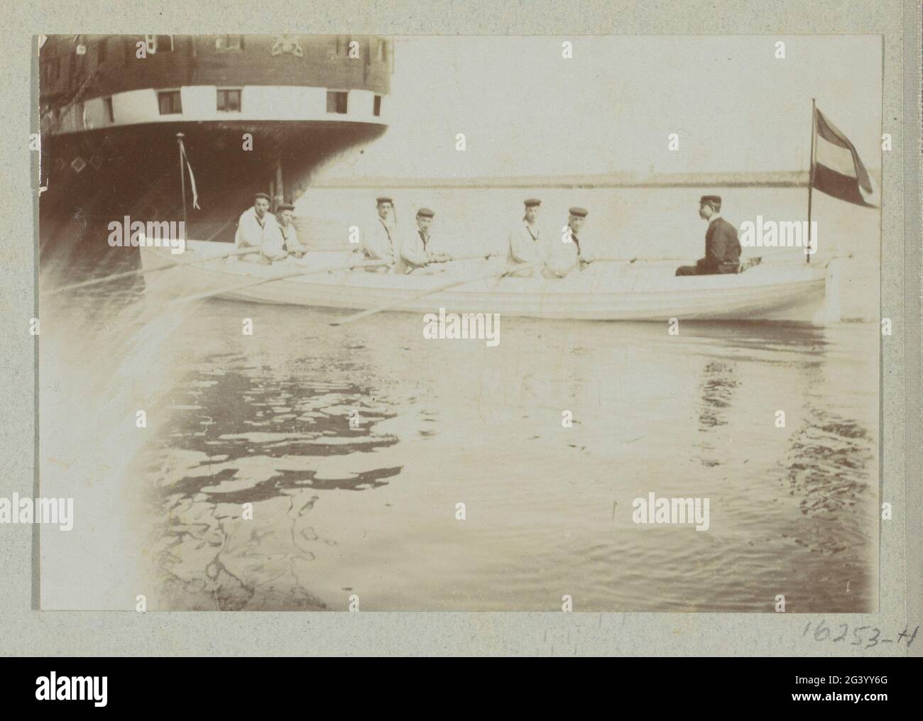 Sailors sail into a rowing boat to their ship Stock Photo - Alamy