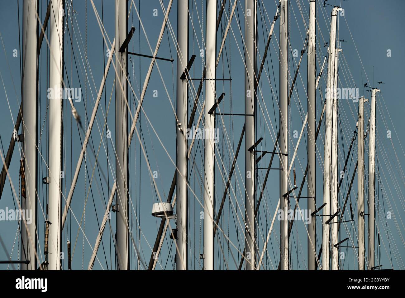 The number of masts of sailboats with the blue sky on a background, a ...