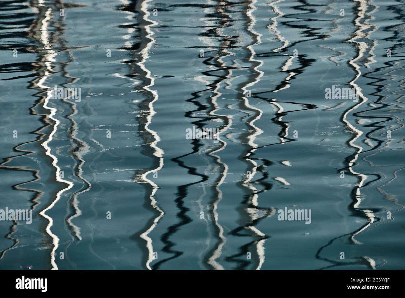 Reflection of masts of sailboats on water, interesting texture, smooth ...