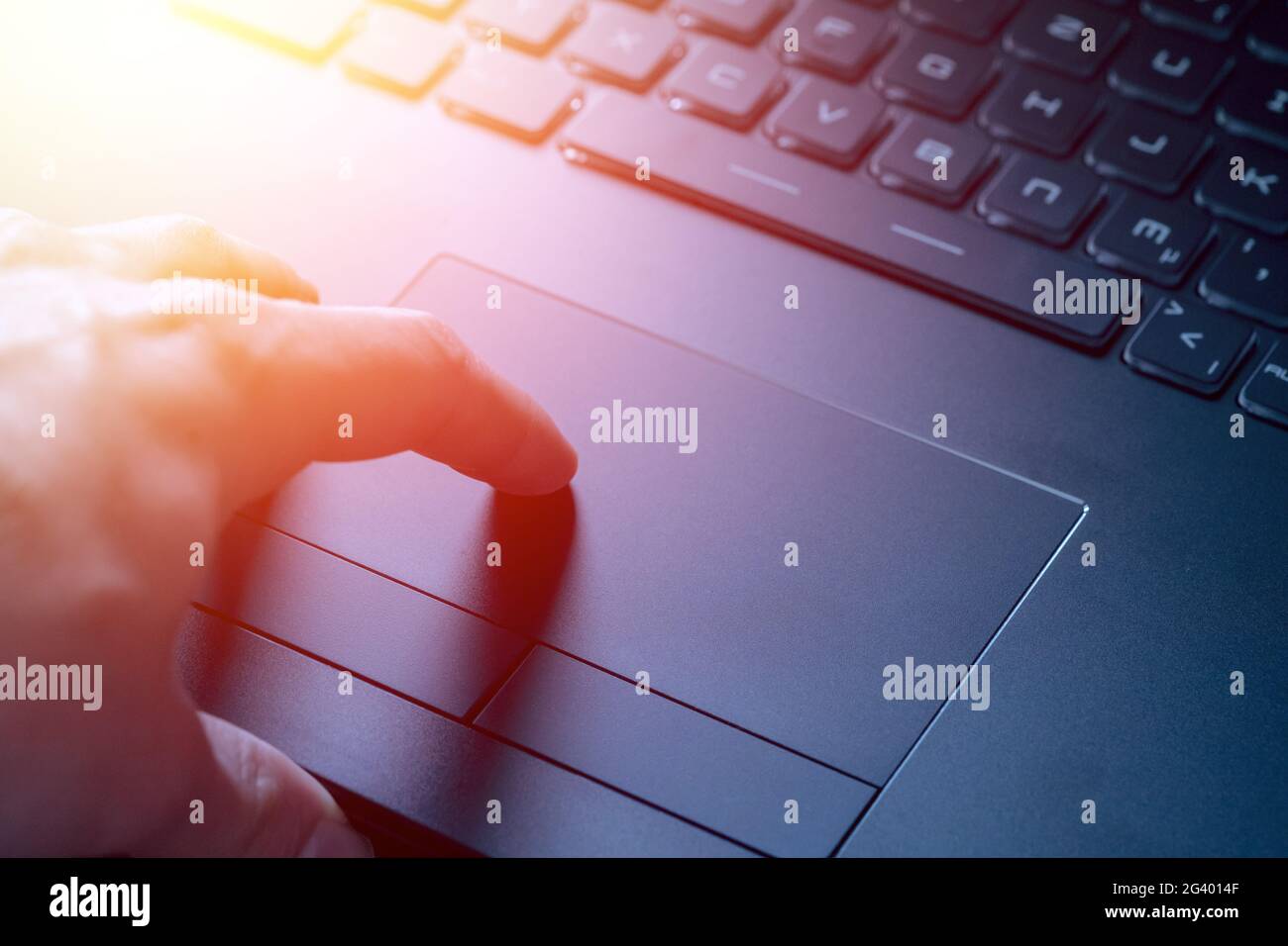 Hands are using a touchpad of laptop, close up picture and sunshine ...