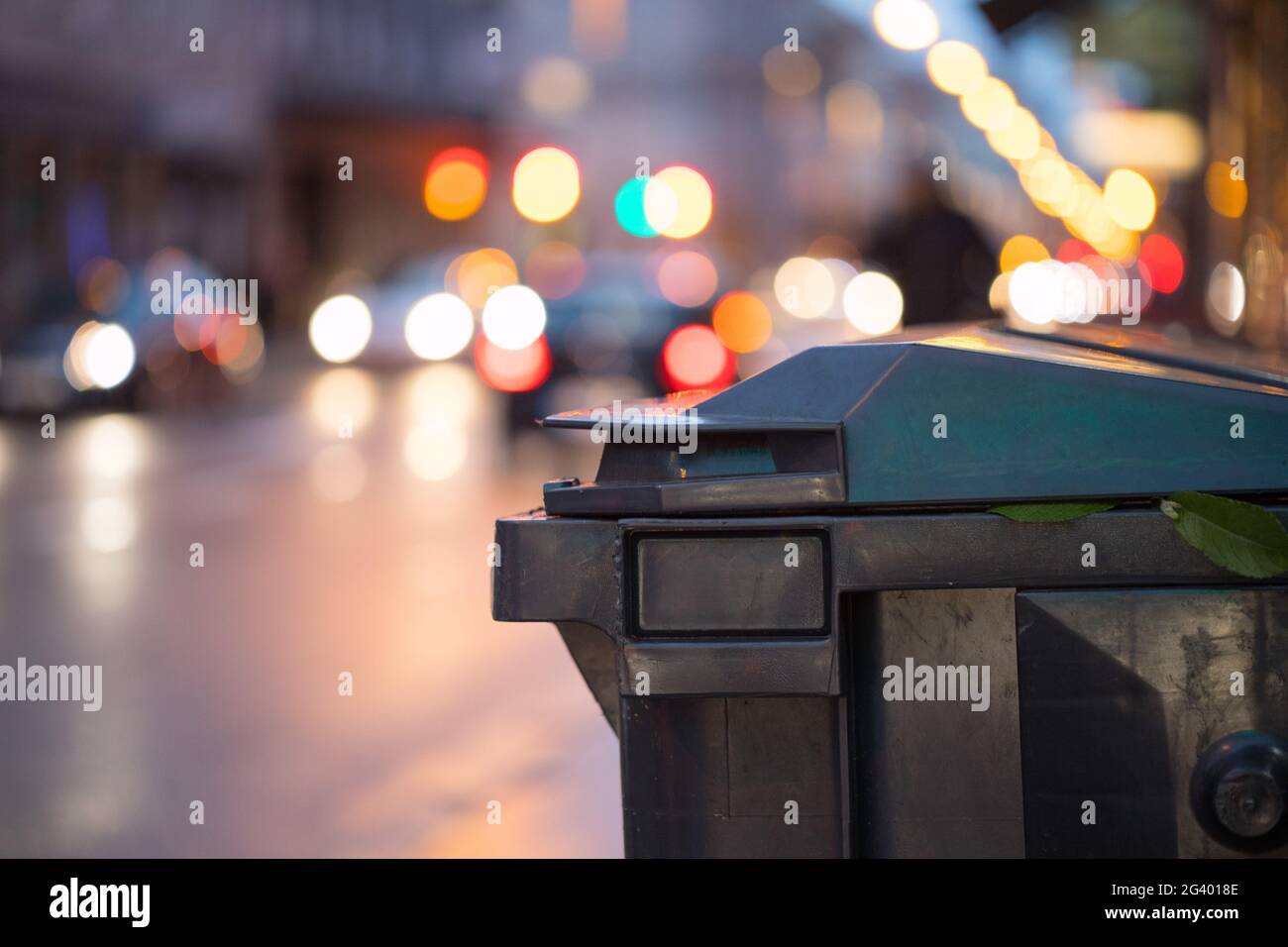 Garbage cans and street lights in urban city, evening Stock Photo - Alamy