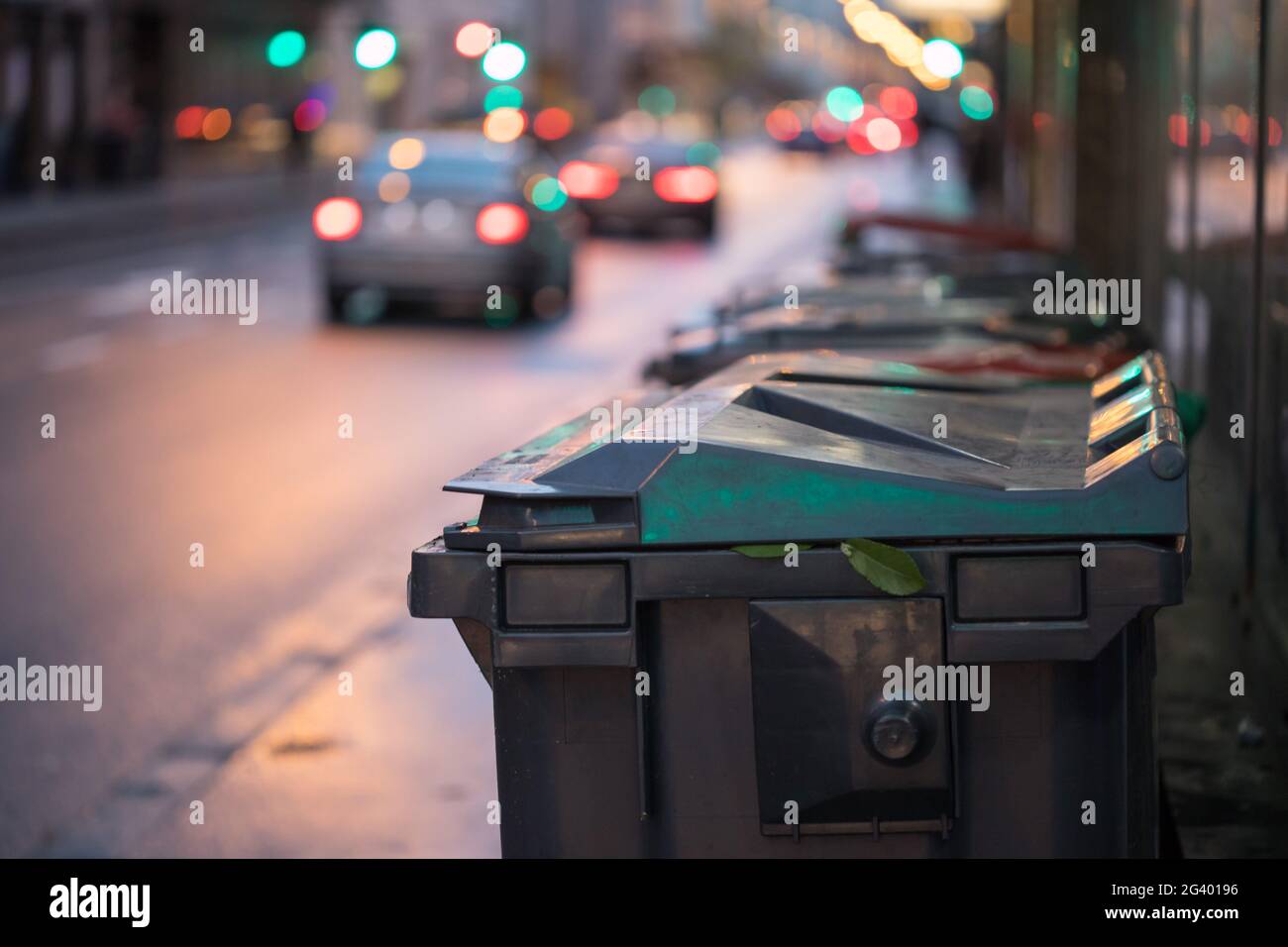 Garbage cans and street lights in urban city, evening Stock Photo - Alamy