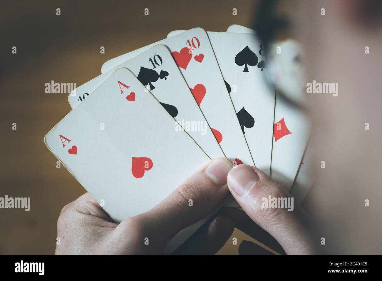 Playing cards: Poker cards in the hand of a man Stock Photo - Alamy