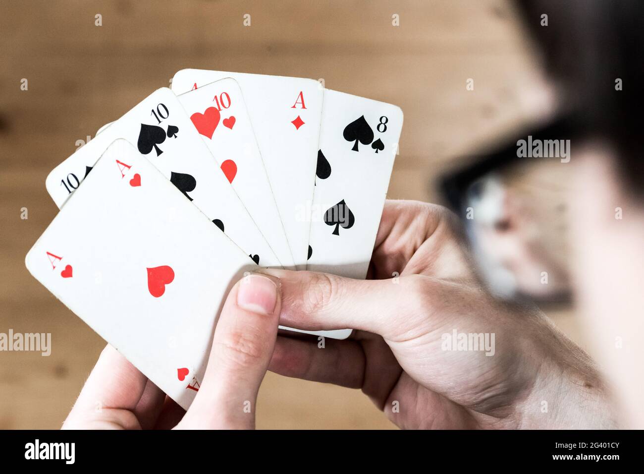 Playing cards: Poker cards in the hand of a man Stock Photo - Alamy