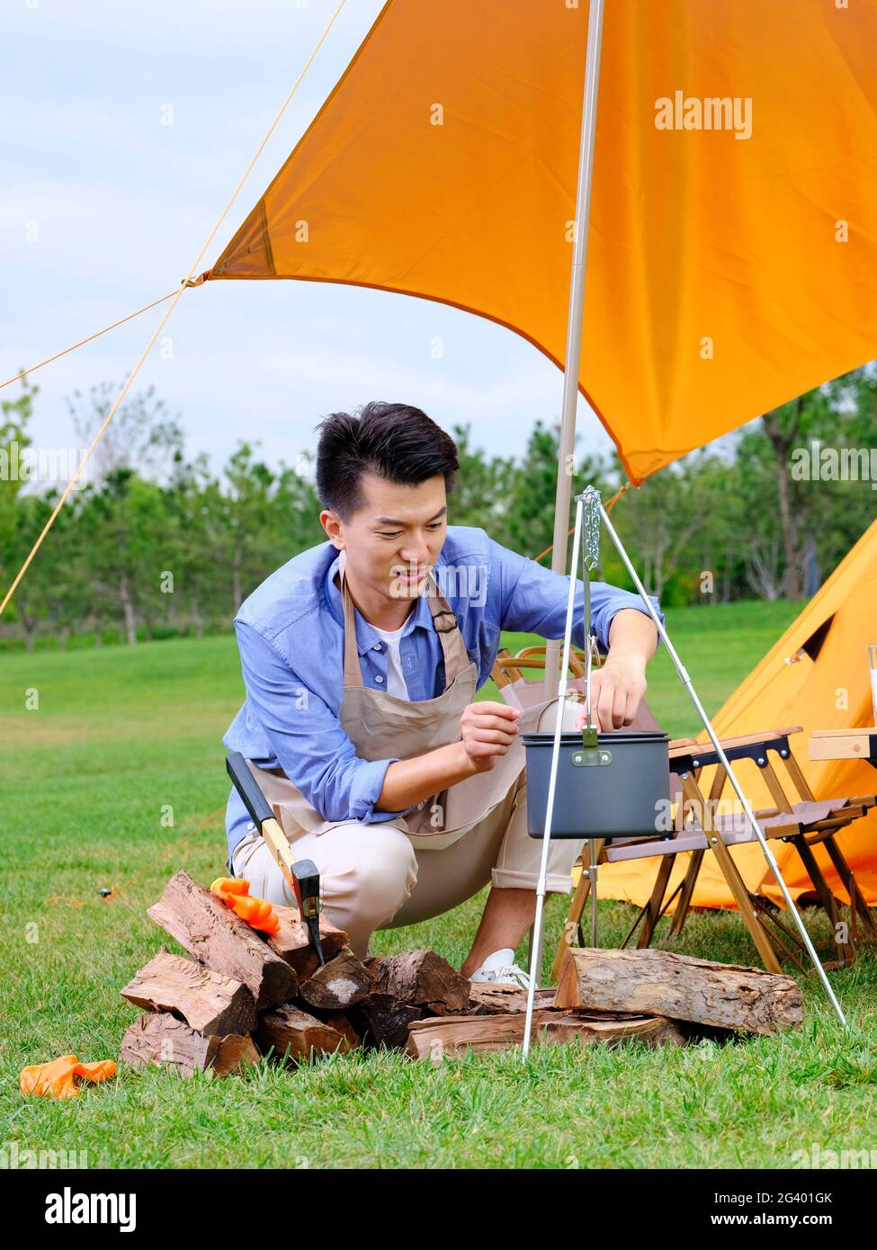 A young man is cooking outside high quality photo Stock Photo - Alamy