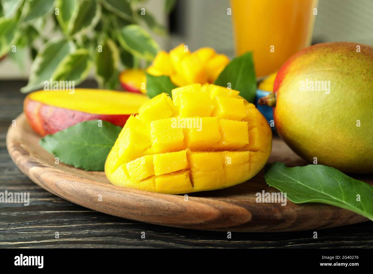 Tasty juicy mango on wooden hi-res stock photography and images - Alamy
