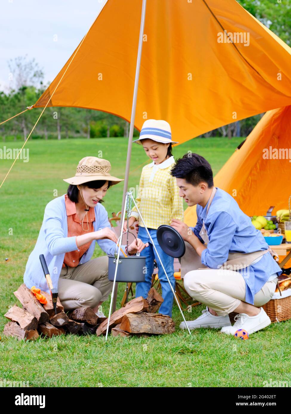 A happy family of three cooks outdoors high quality photo Stock Photo ...
