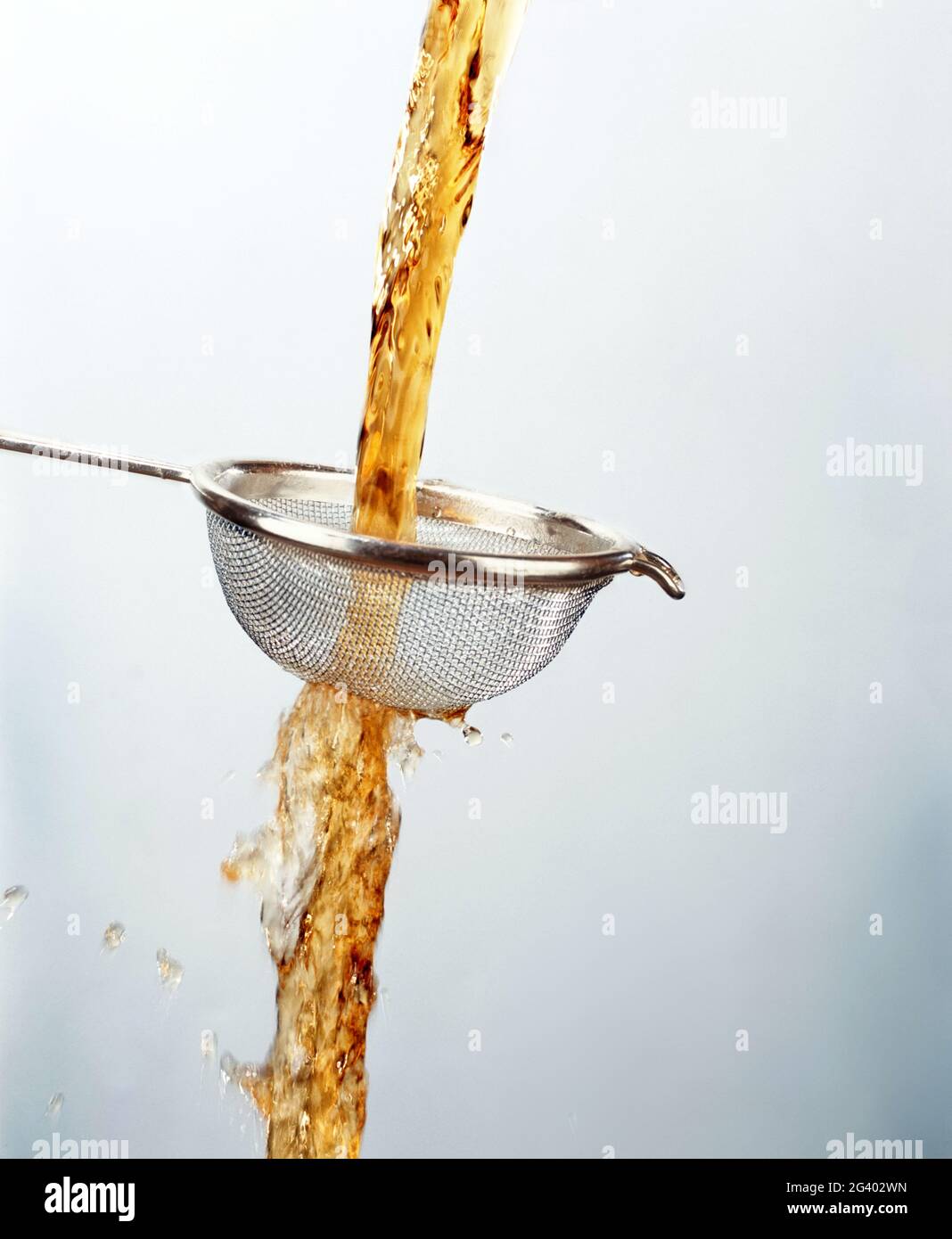 Strainer With Stream Of Tea Stock Photo - Alamy
