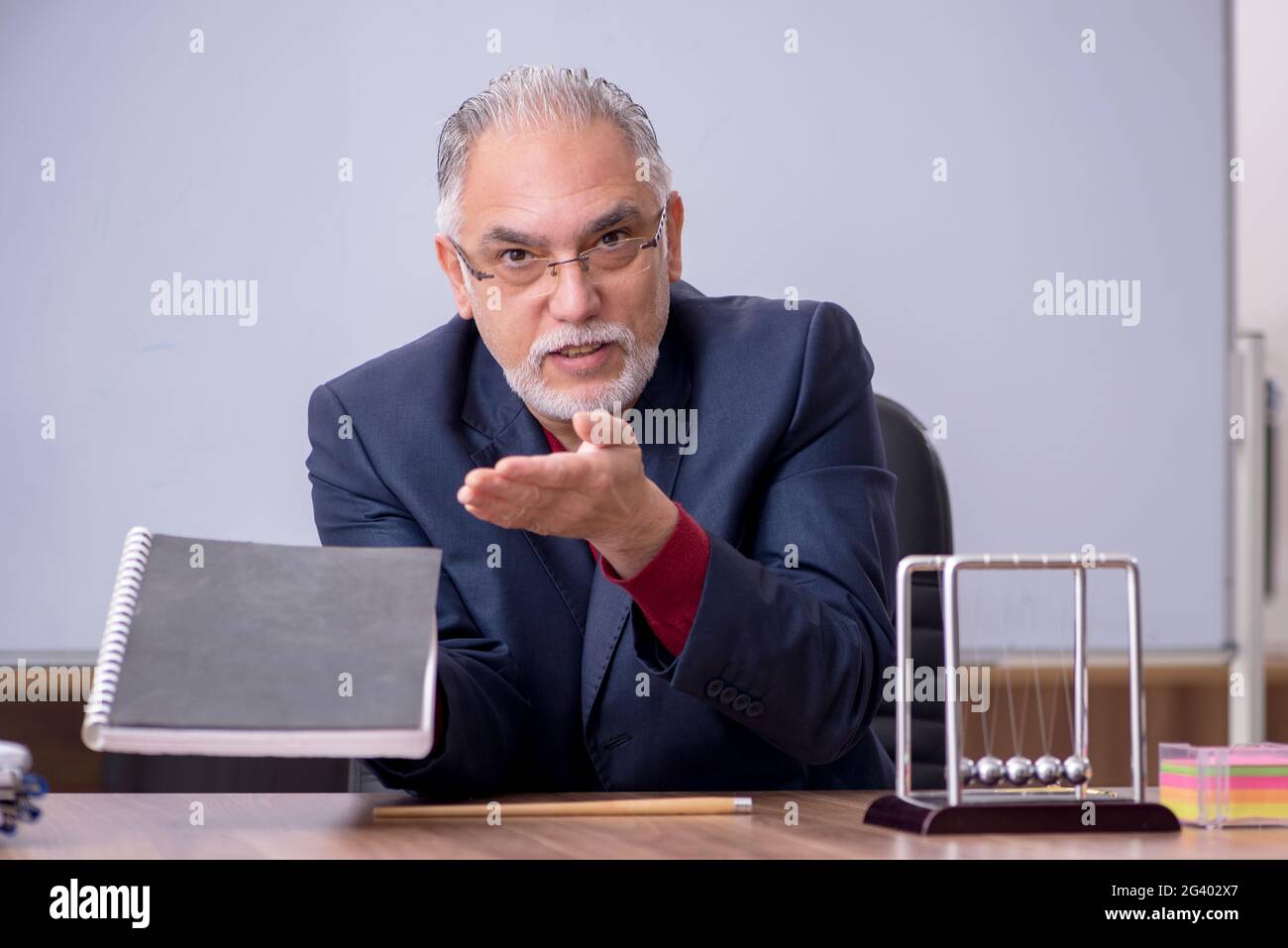 Old teacher physicist sitting in the classroom Stock Photo - Alamy