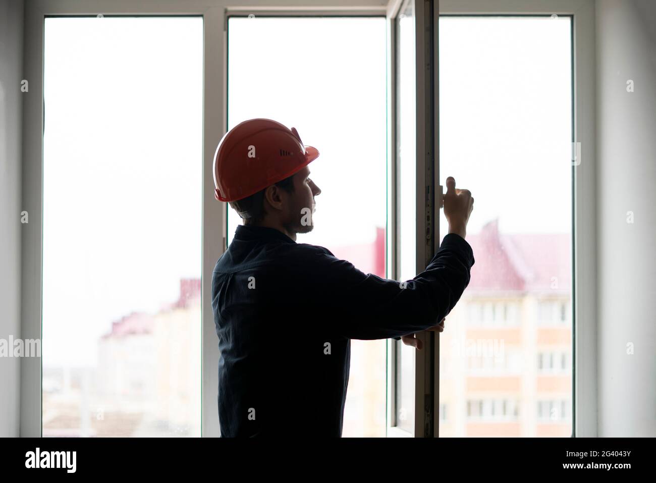 professional handyman worker install and adjust window in the house ...
