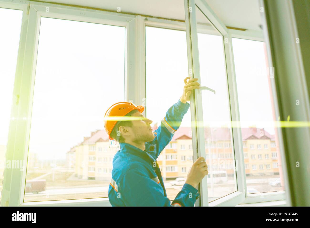 professional handyman worker install and adjust window in the house ...