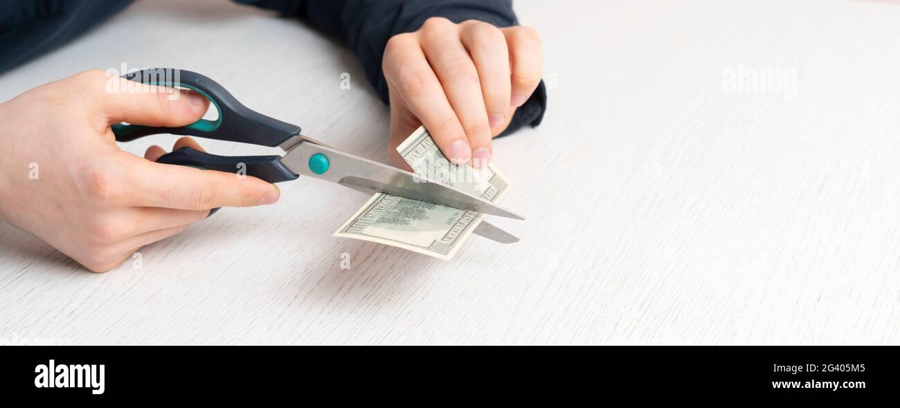 Scissors cutting dollar sign hi-res stock photography and images - Alamy