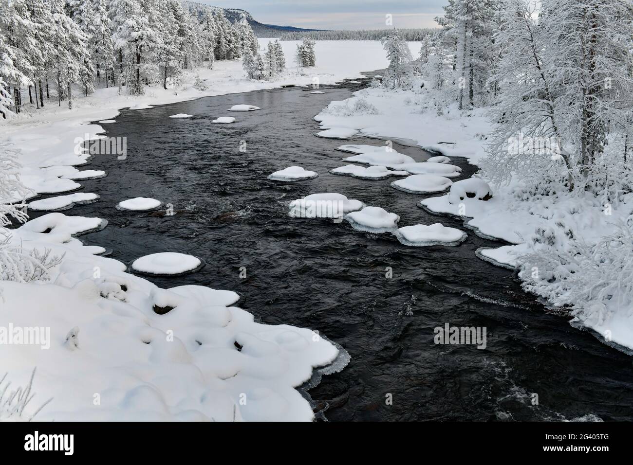 A river in winter surrounded by ice and snow in Lapland, Arjeplog ...