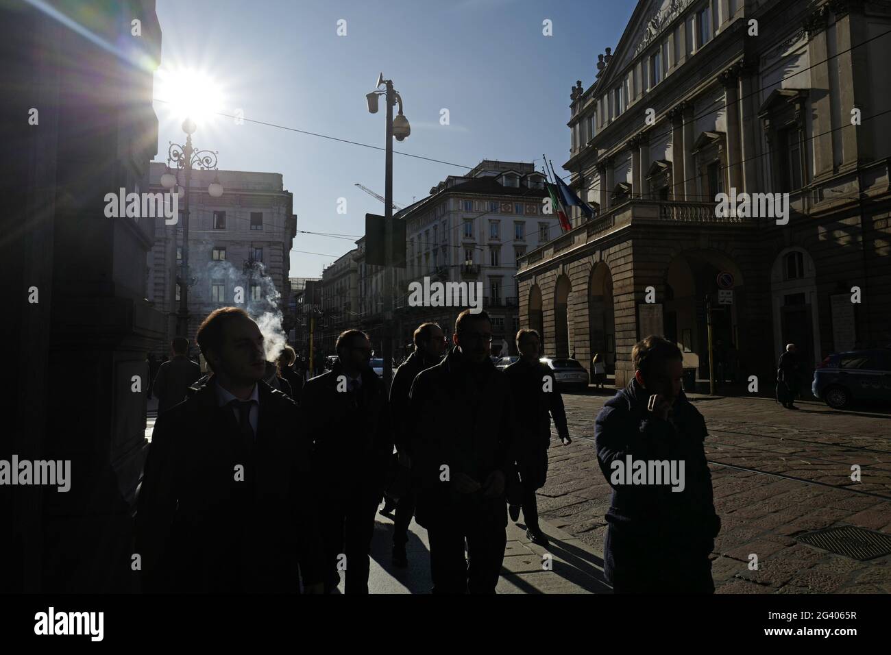 People walk in La Scala square, with the historical theater building ...