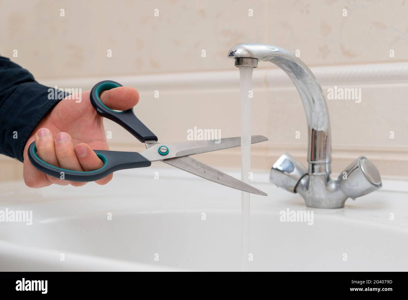 reduce water concumption concept, person cut the water stream from ...
