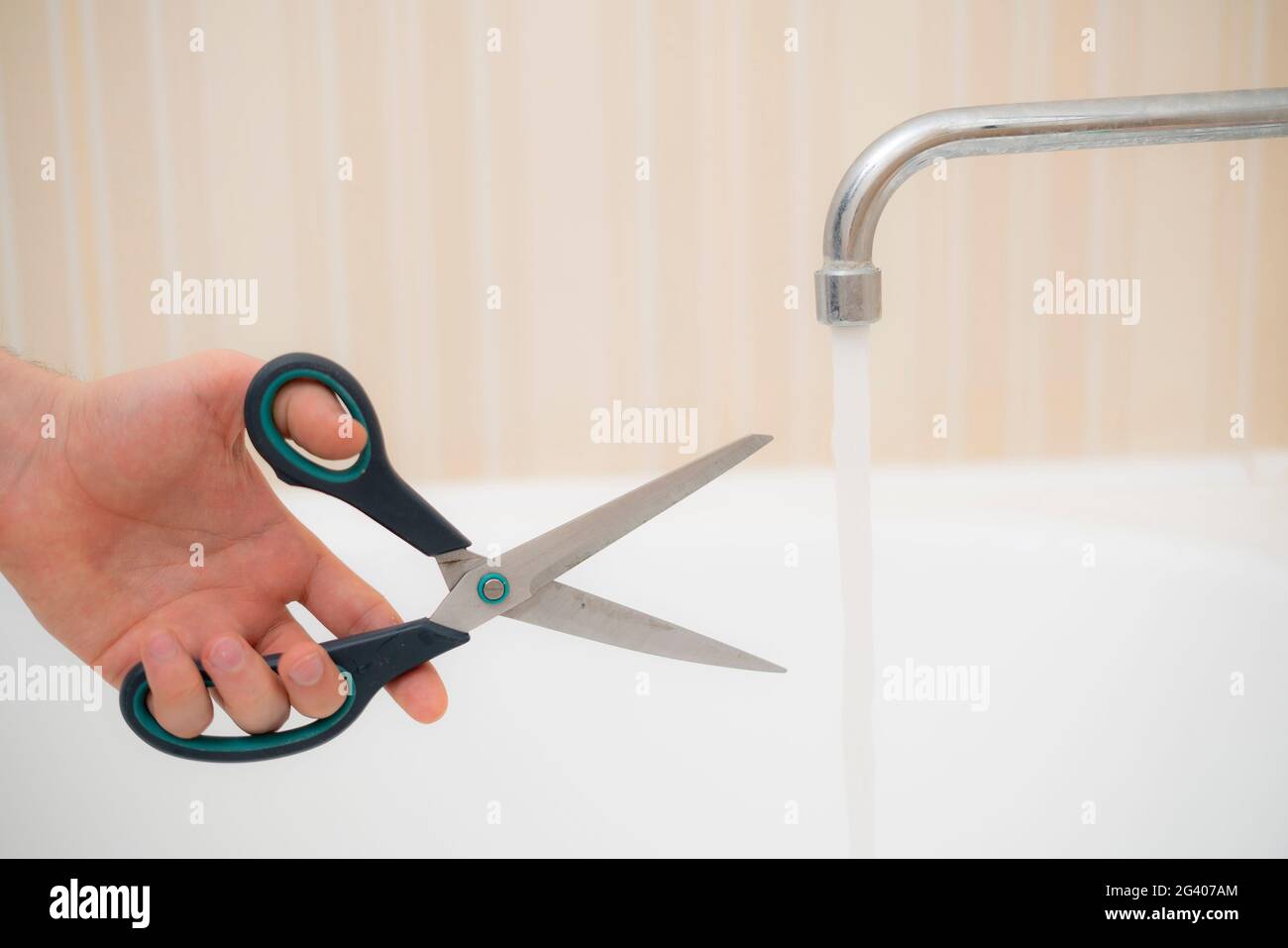 reduce water concumption concept, person cut the water stream from ...