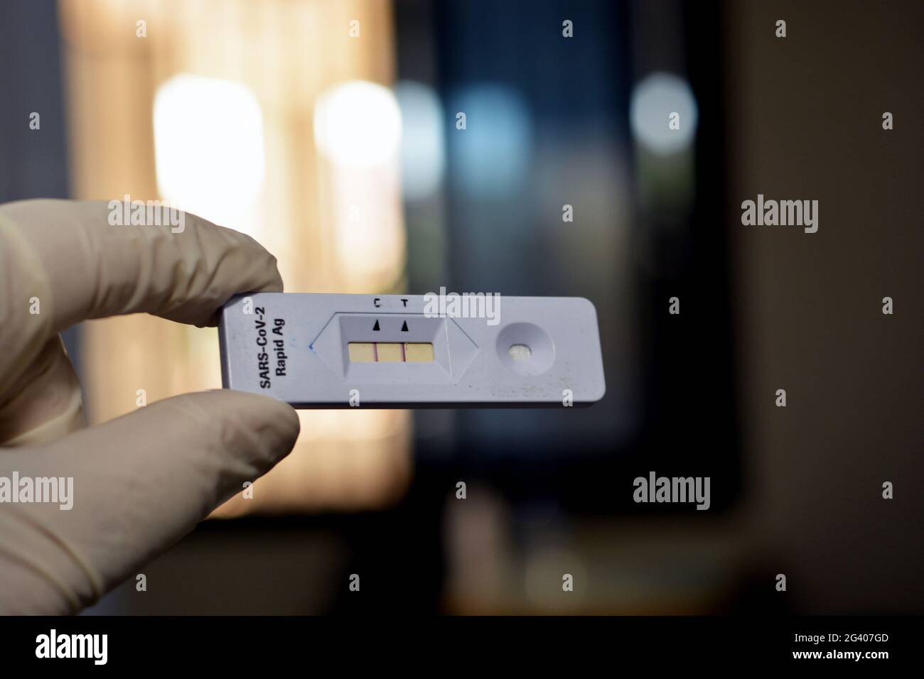 A medical personnel shows a positive result of SARS-COV-2 Rapid Ag test ...