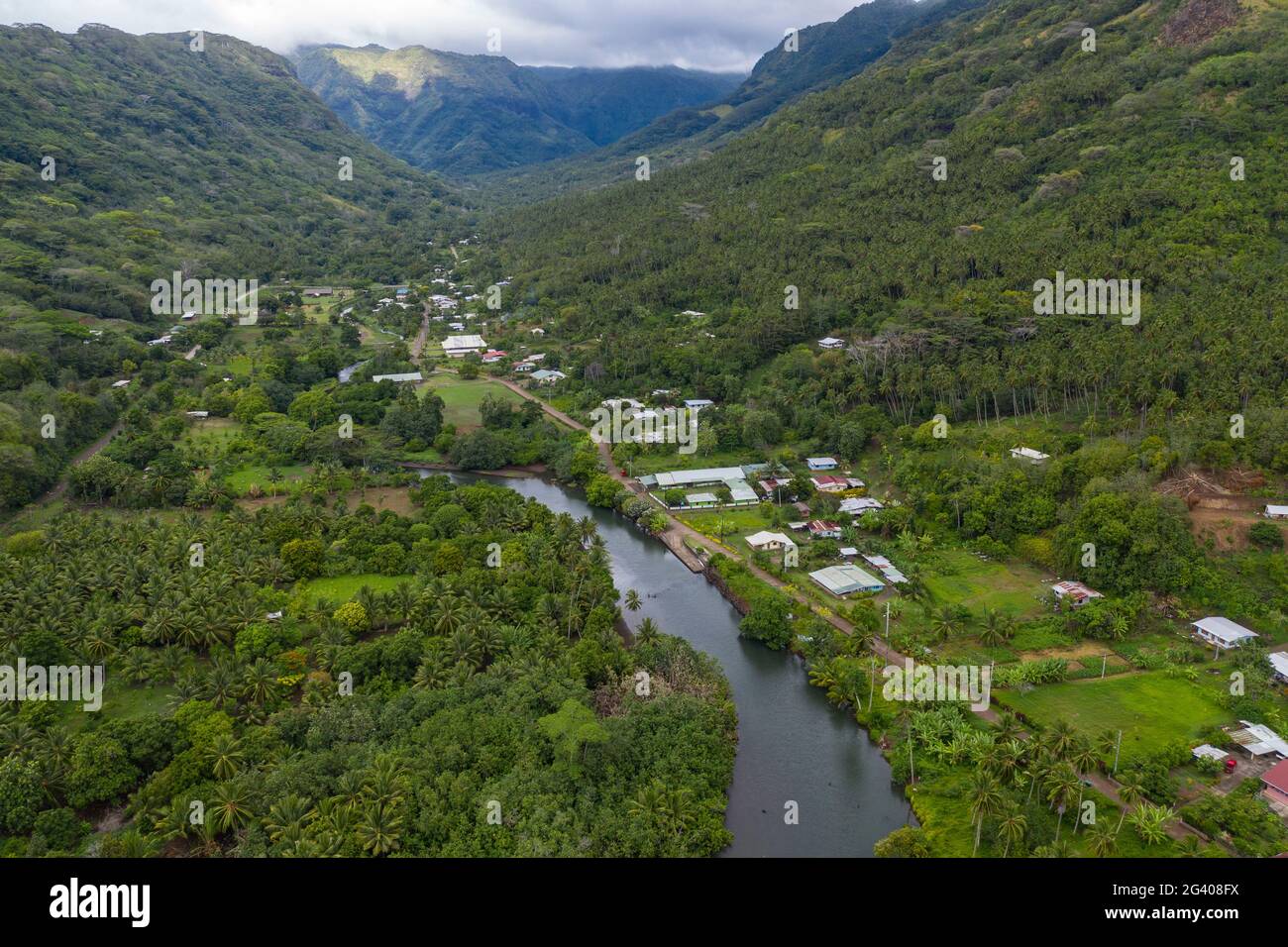Aerial view of river and houses in Taipivai Valley, Taipivai, Nuku Hiva ...
