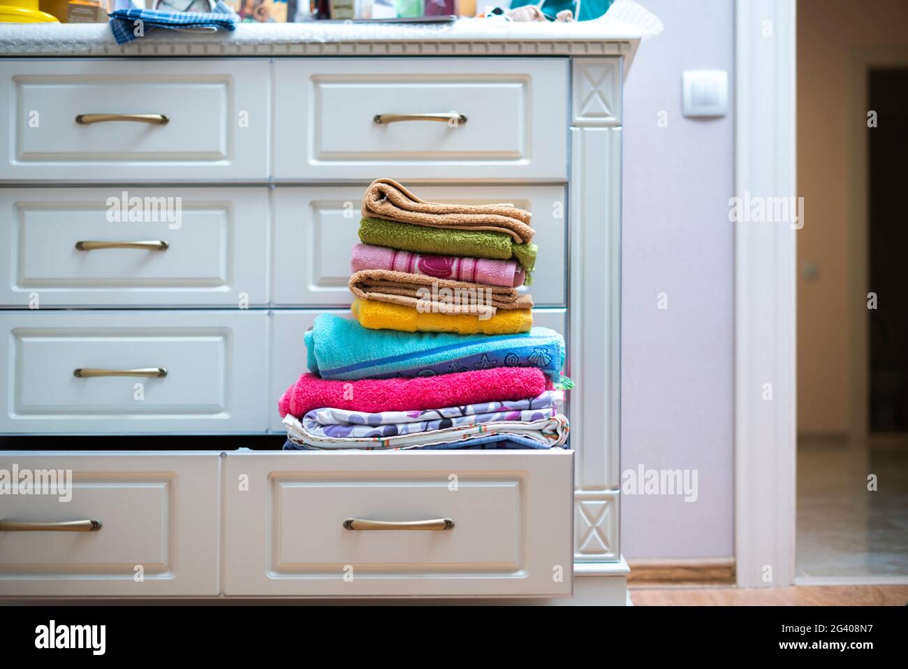 stack of new clean fresh color towels textile on the shelf in laundry ...