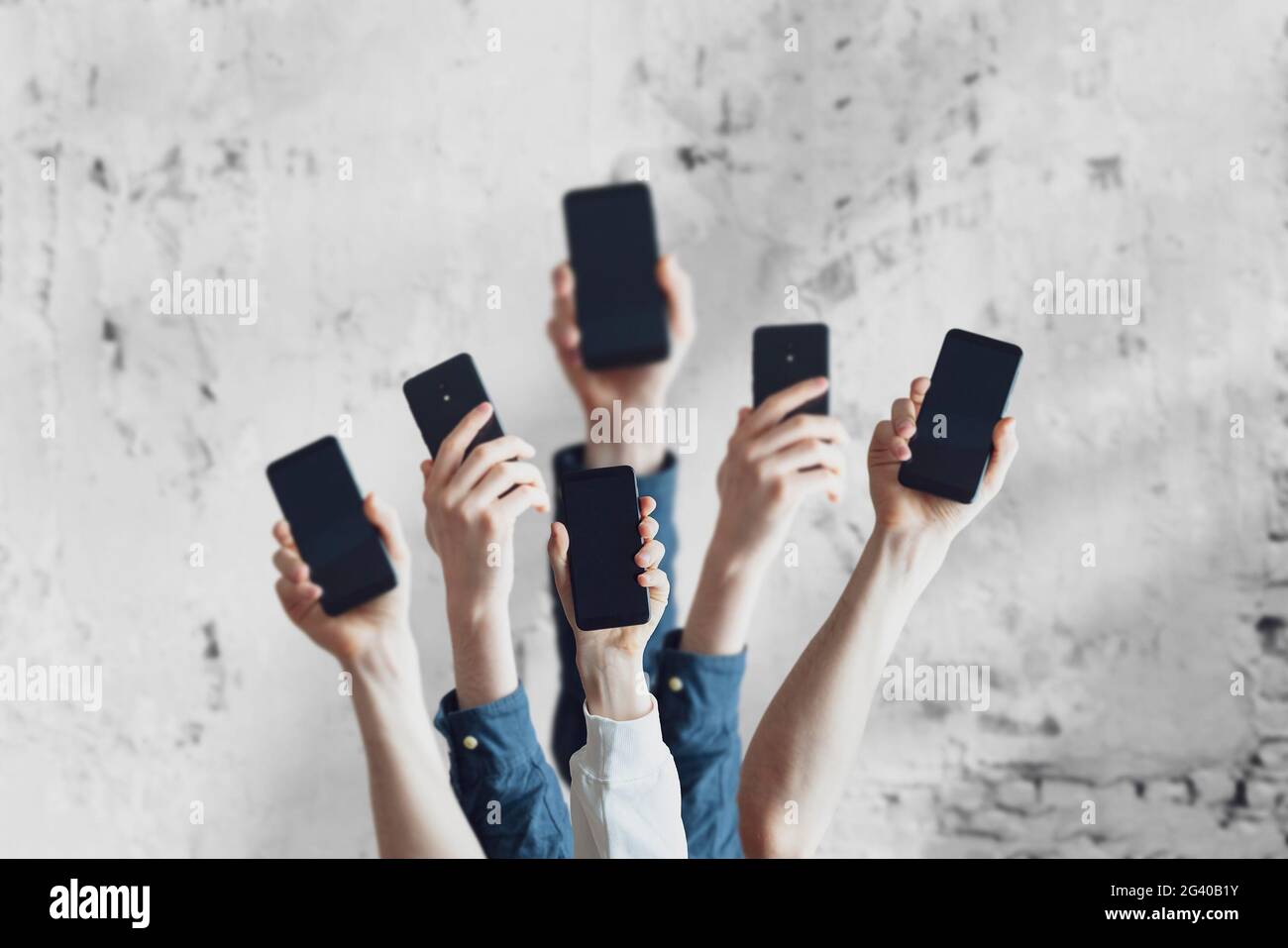 Group hands holding phones hi-res stock photography and images - Alamy