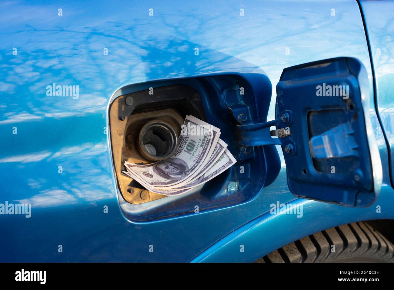 refill the car with fuel, some cash money inside the fuel tank, idea of ...