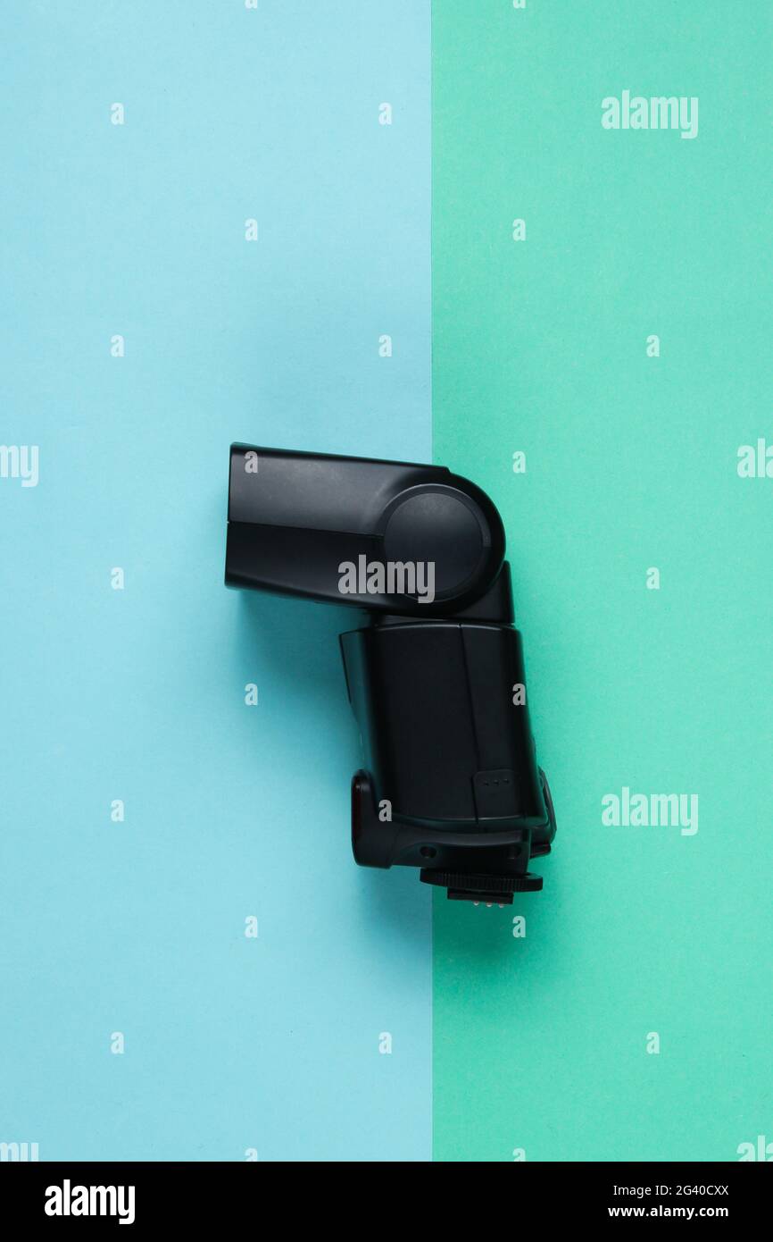 Camera flash on colored paper background. Top view Stock Photo - Alamy