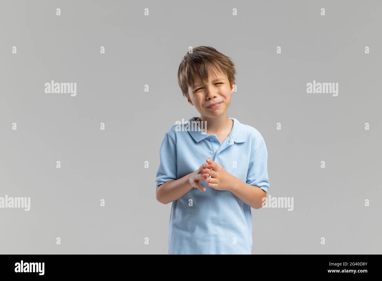 Half-length portrait of Caucasian little boy posing isolated over gray ...
