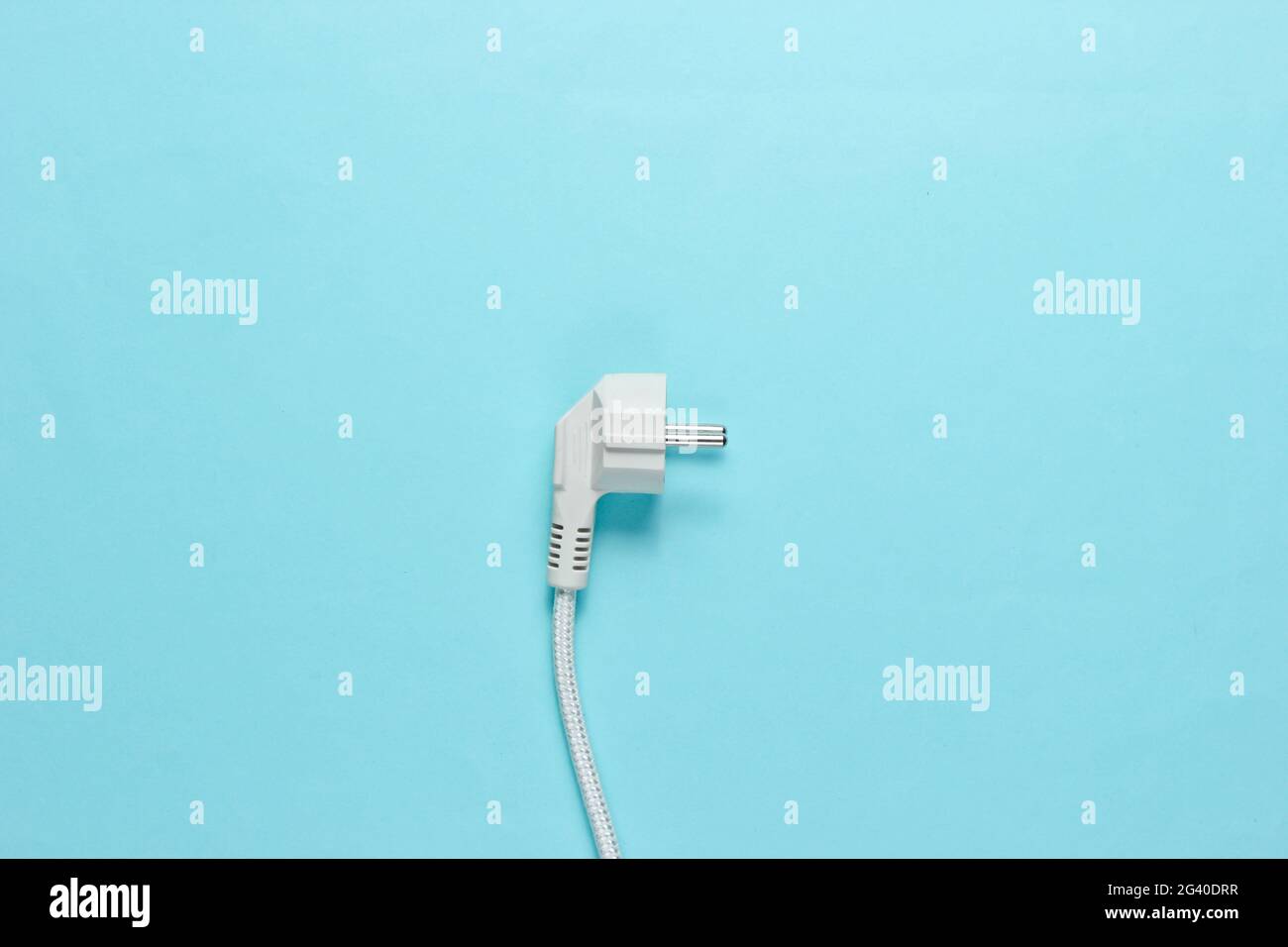 Electric plug on the blue view. Top view Stock Photo - Alamy
