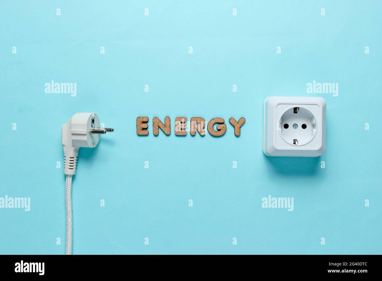 Power plug and socket with the word Energy on blue background. Top view ...