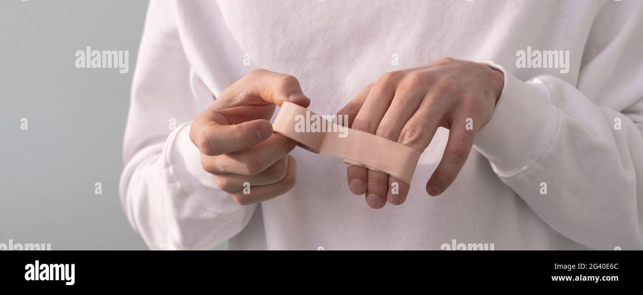 applying medical tape to the hand, skin pain protection plaster Stock ...