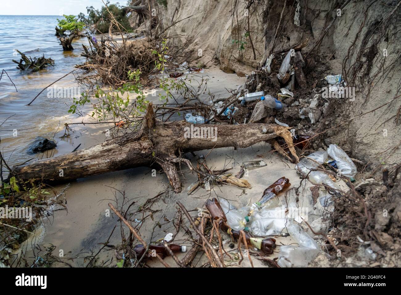 People and ecology. Riverside pollution. Trash and plastics at the ...