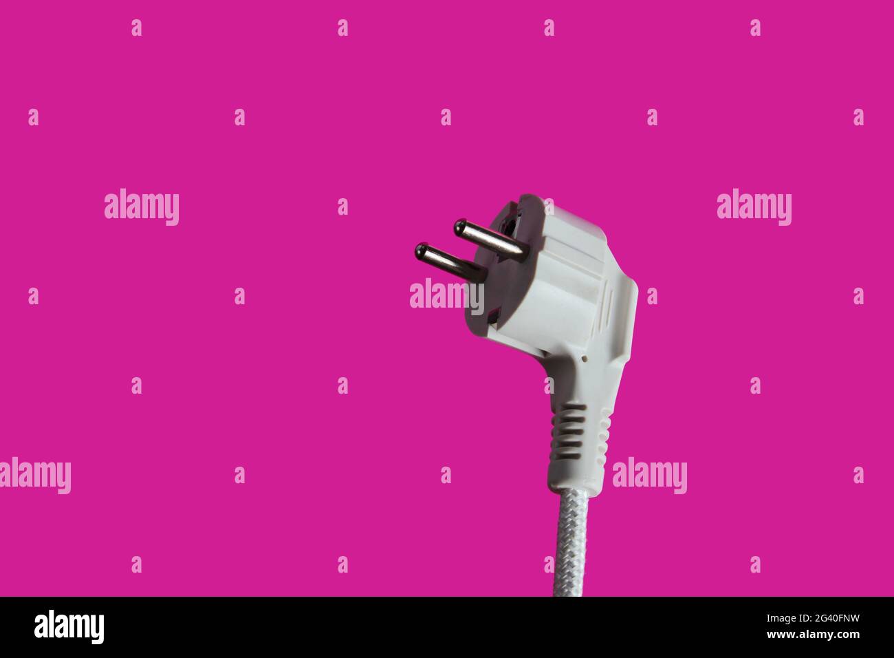 Electric plug closeup on pink background Stock Photo - Alamy