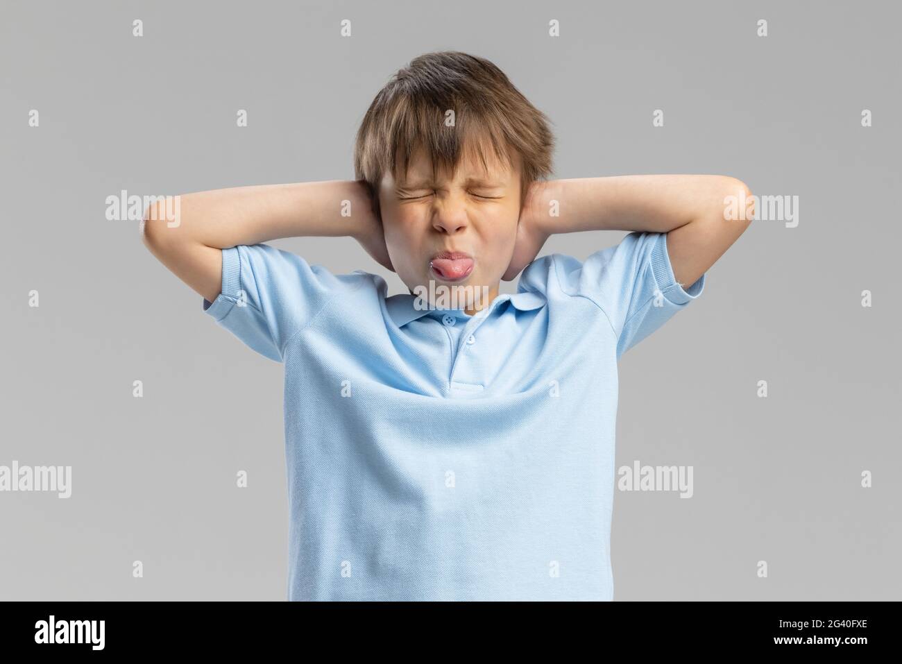 Half-length portrait of Caucasian little boy posing isolated over gray ...