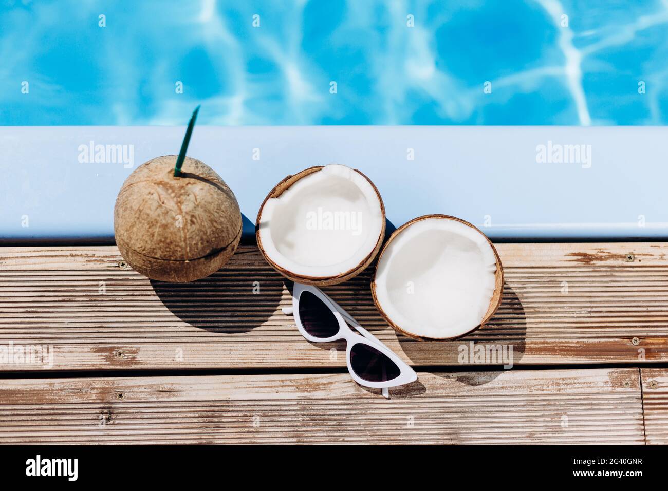Coconut and glasses by the pool. Coconut cocktail Stock Photo - Alamy