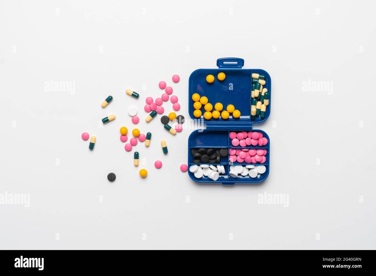 a plastic pill box container with bunch of color pills medication ...