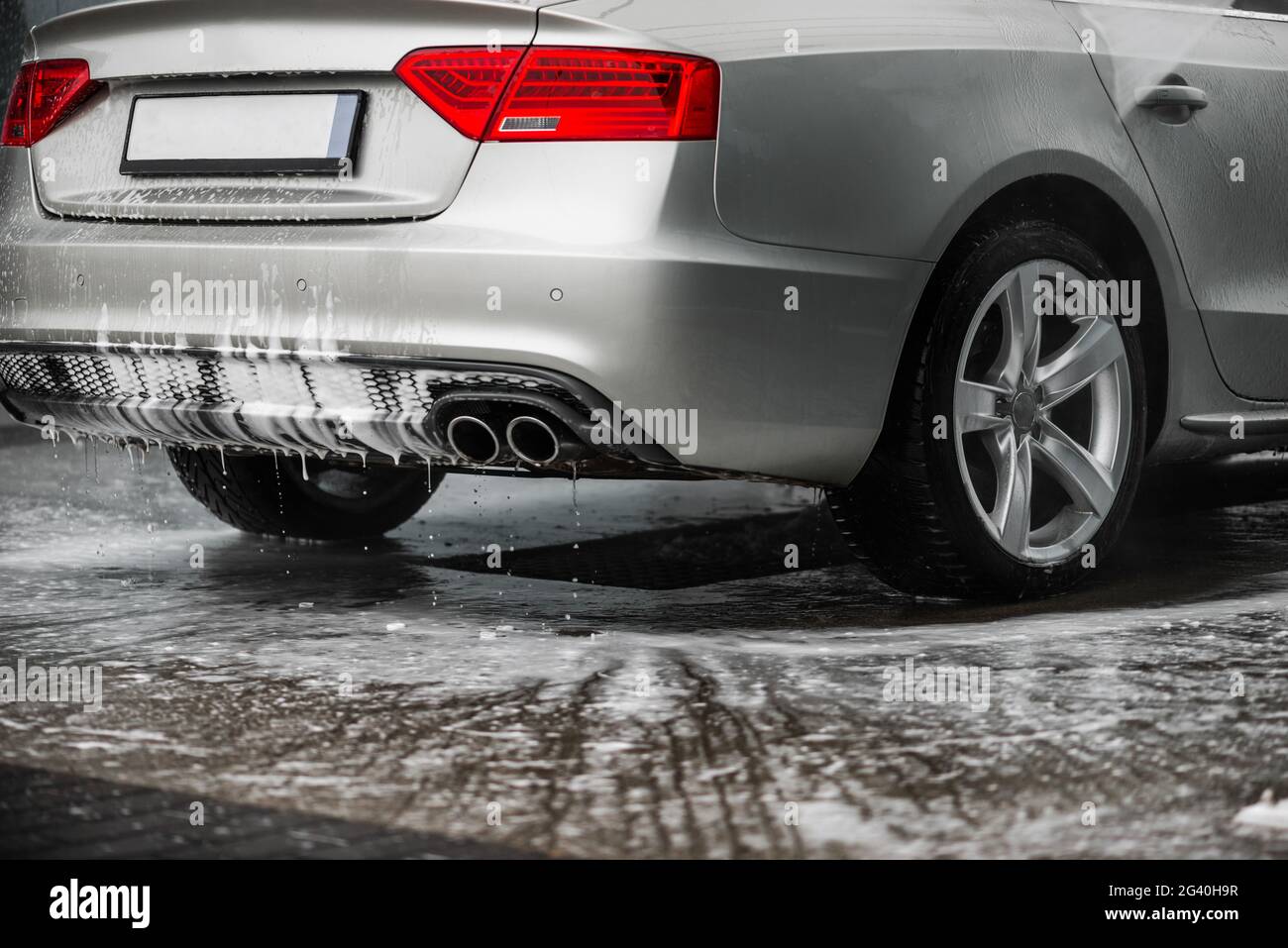 Washing grey car in the car wash indoors. - Back headlights view Stock ...
