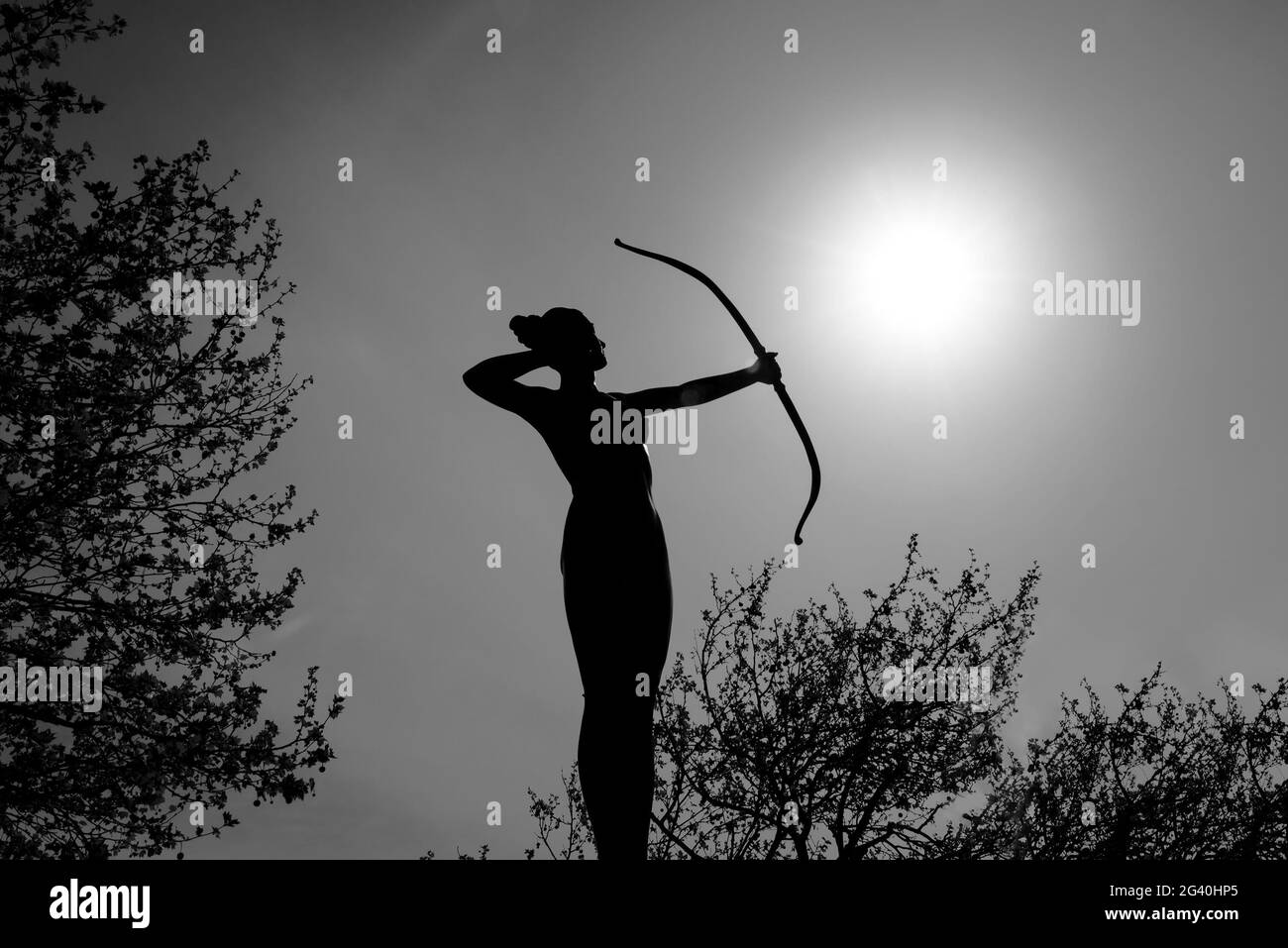 Statue of a woman Archer Silhouette with a bow target the sun Stock ...