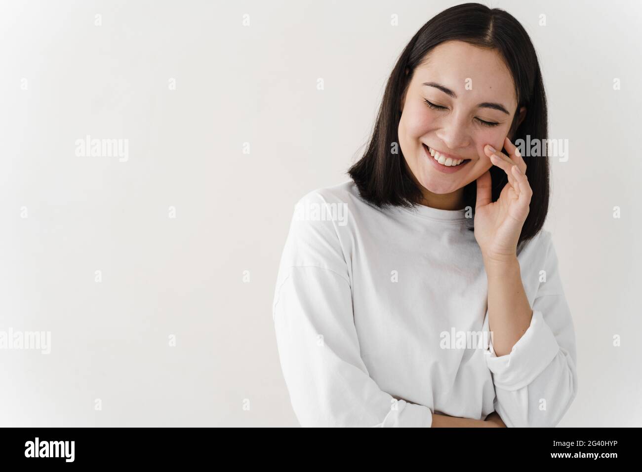 Cute, shy girl smiling beautifully on a white background. Girl on a ...