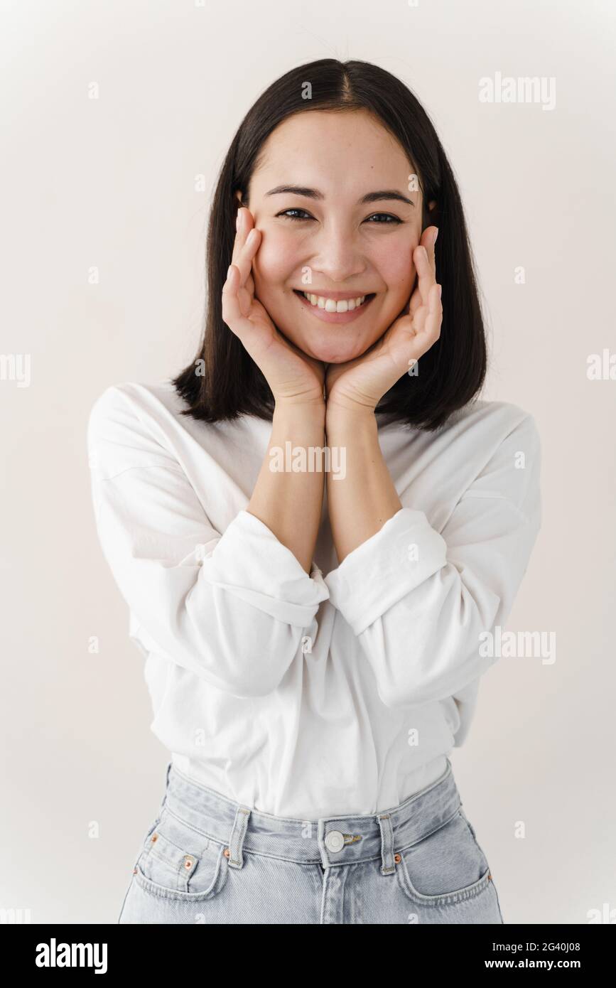 Surprised excited woman on a green background. Cheerful female model ...
