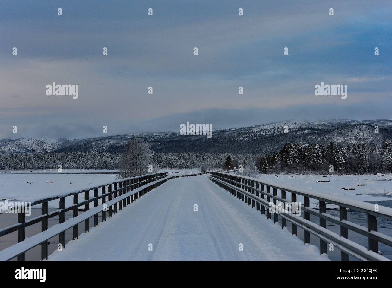 Snow-covered bridge over a lake in winter in Lapland, Arjeplog, Sweden ...